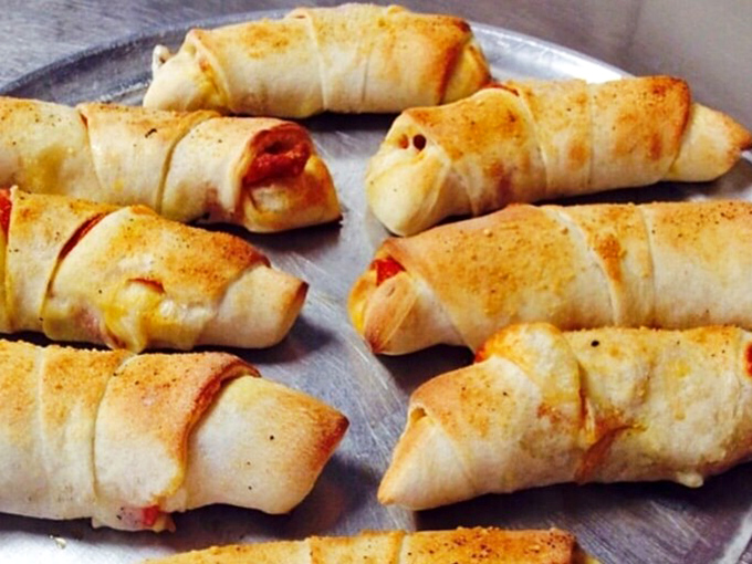 These golden-brown stromboli crescents are what happens when pizza ingredients decide to get all dressed up and go somewhere fancy.