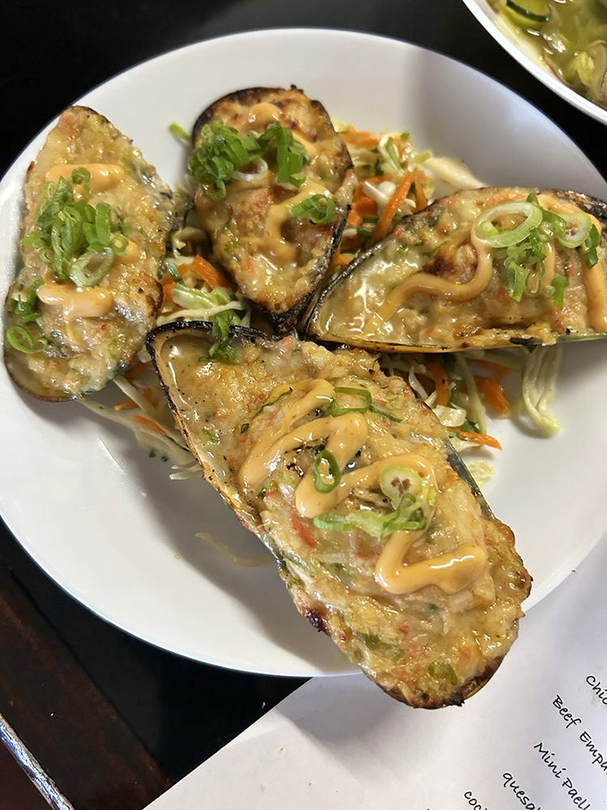 These stuffed mussels aren't just appetizers—they're tiny seafood convertibles topped with a drizzle that makes taste buds stand at attention.