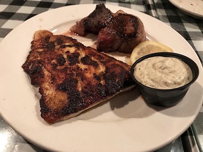 Land meets sea in this culinary romance &ndash; a tender filet mingles with blackened fish on a plate that satisfies all your cravings at once.