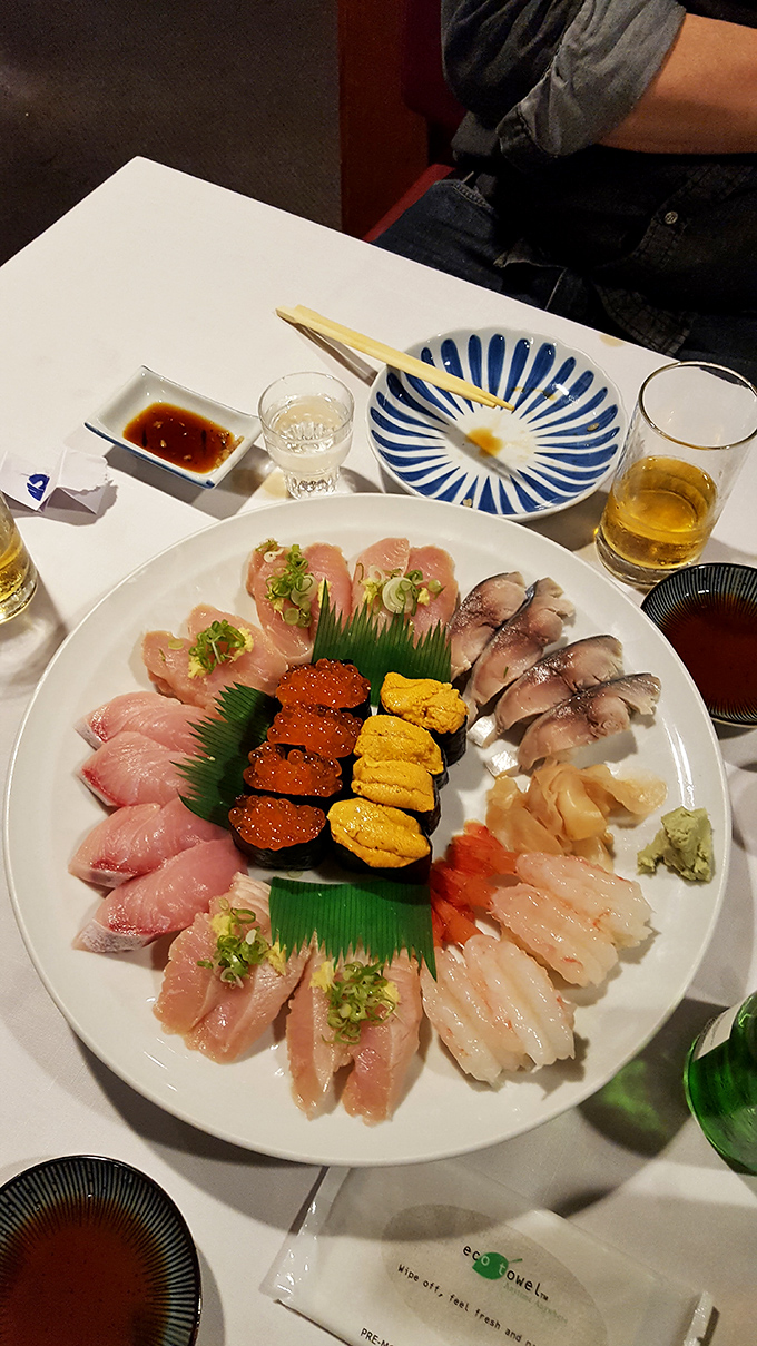 Sushi as art form&mdash;a pristine plate where vibrant uni meets glistening fish, arranged with the precision of a Japanese garden.