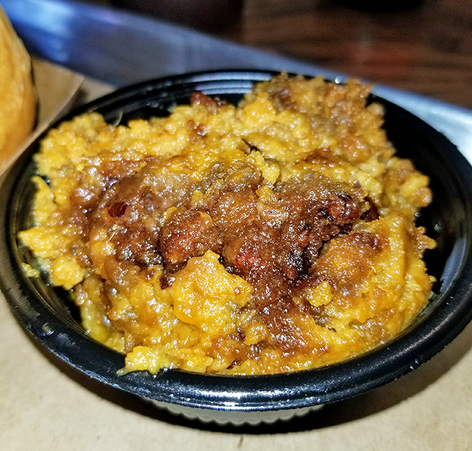 This isn't just mac and cheese&mdash;it's a golden-crusted lake of comfort where chunks of meat have found their happy place. Grandma would approve, then ask for seconds.