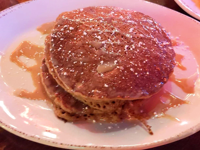 Sweet potato pancakes stacked high and glistening with syrup, turning breakfast into an edible work of art.