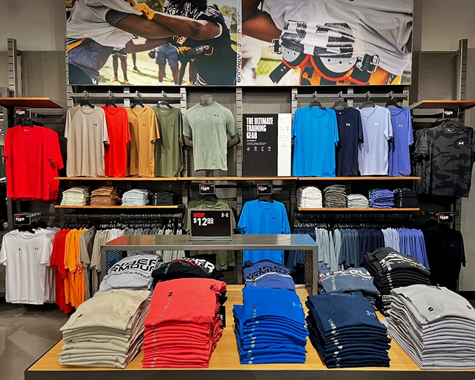 The Under Armour display&mdash;where everyday athletes find their uniform. A color-coded paradise of performance wear that whispers, "You could be a morning person."