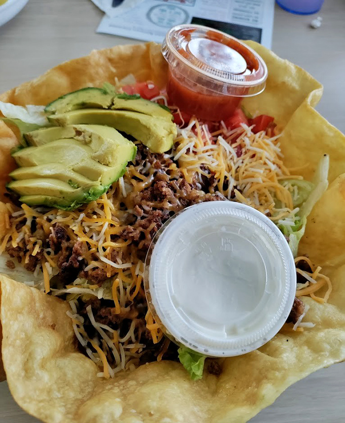 A taco salad that refuses to be boring—crispy shell, seasoned meat, fresh toppings, and enough cheese to make Wisconsin proud.