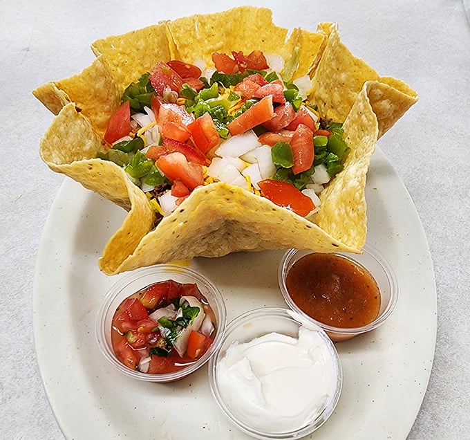 This taco salad bowl isn't just food; it's edible architecture. Fresh pico de gallo and sour cream waiting to transform your ordinary lunch hour. 