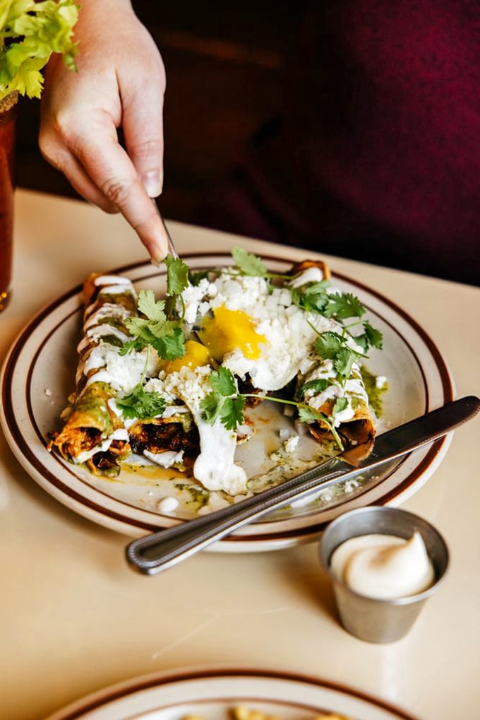 These enchiladas aren't just visiting Iowa—they've been granted permanent residency status with that perfect drizzle of crema and fresh cilantro.