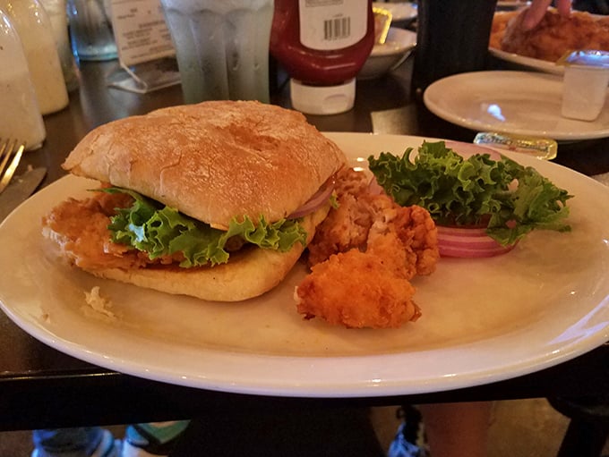 A sandwich that understands the assignment: golden-fried goodness, fresh greens, and a bun that knows its role is to showcase, not overshadow.