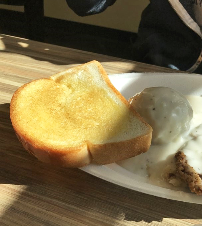 Texas toast so perfectly golden it deserves its own Instagram account, ready to soak up every last drop of that peppery cream gravy.