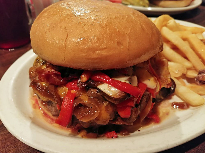 The Ultimate Burger lives up to its name with peppers, bacon, and enough toppings to require architectural planning.