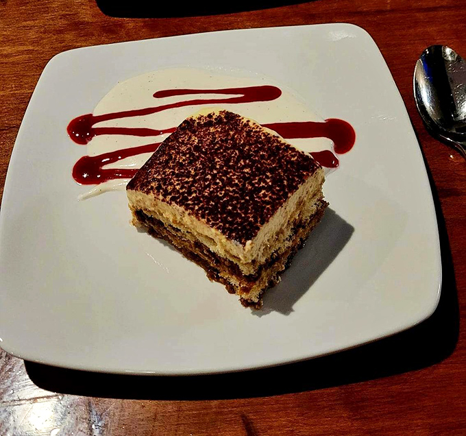 Tiramisu that strikes the perfect balance between coffee, mascarpone, and cocoa. The artful sauce drizzle isn't just pretty—it's a flavor roadmap.