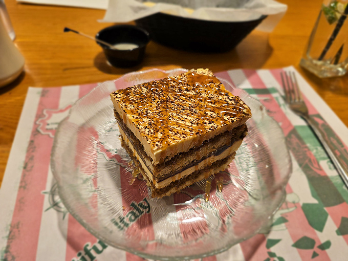 Tiramisu with layers so perfect they could teach geology a thing or two. Coffee-soaked ladyfingers supporting that cloud of mascarpone&mdash;architectural brilliance!