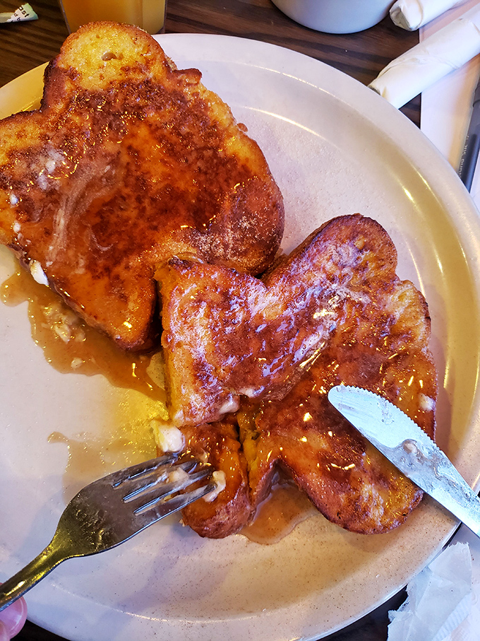 French toast that makes regular toast question its life choices – thick, custardy, and dusted with powdered sugar democracy.