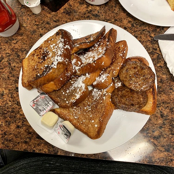 French toast that would make a Parisian jealous&mdash;golden-brown, dusted with powdered sugar, and generous enough to share (though you probably won't want to).