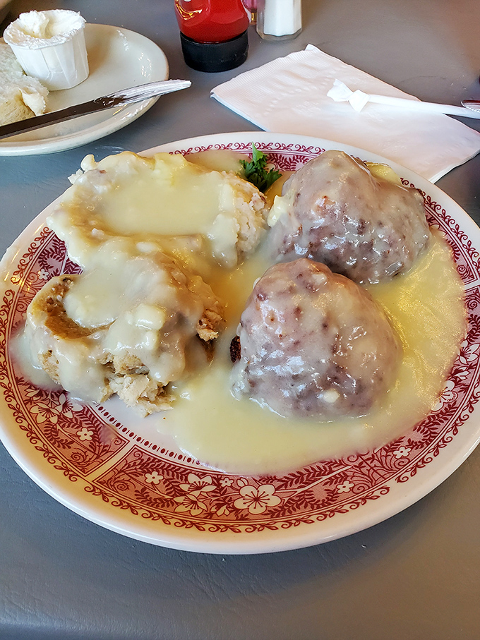 Turkey croquettes lounging in a pool of gravy next to mashed potatoes&mdash;like Thanksgiving decided to take a vacation to comfort food paradise.
