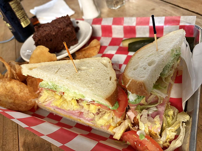 This isn't just a sandwich, it's architecture with flavor &ndash; layers of turkey, cheese, and fresh veggies stacked between pillowy bread slices, with chips and pickle standing guard.