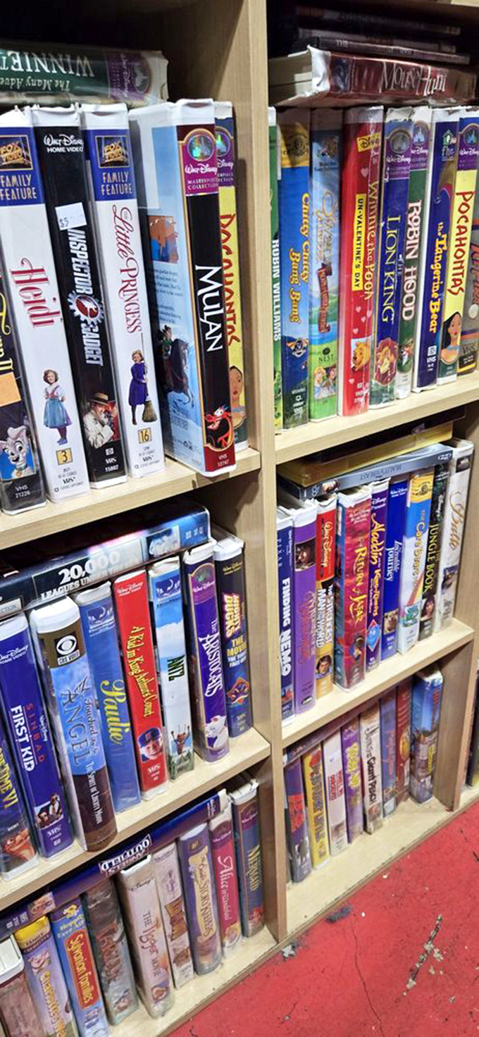 Remember these rectangular treasures? Disney VHS tapes line the shelves like a time capsule from the era when "be kind, rewind" was life's golden rule.