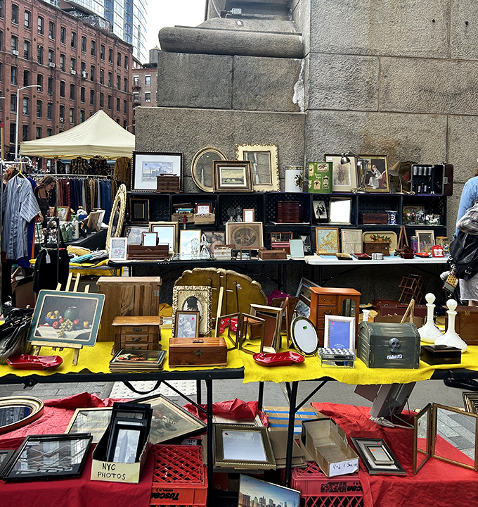 A carefully curated chaos of vintage frames and curiosities. Someone's grandmother's attic treasures become tomorrow's conversation pieces in Brooklyn apartments.