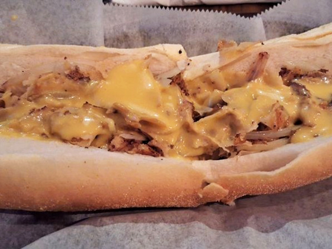Behold the cheesesteak &ndash; melty, messy perfection that makes you forget table manners exist. Worth every napkin you'll need afterward.