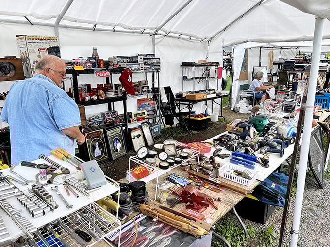 Tools of every trade fill tables under white canopy tents. The unspoken motto: "Someone somewhere needs exactly this thing."