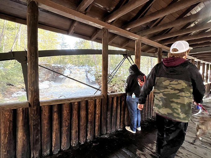 The historic covered bridge offers more than shelter—it frames the falls like nature's own masterpiece, complete with the soundtrack of rushing water below.