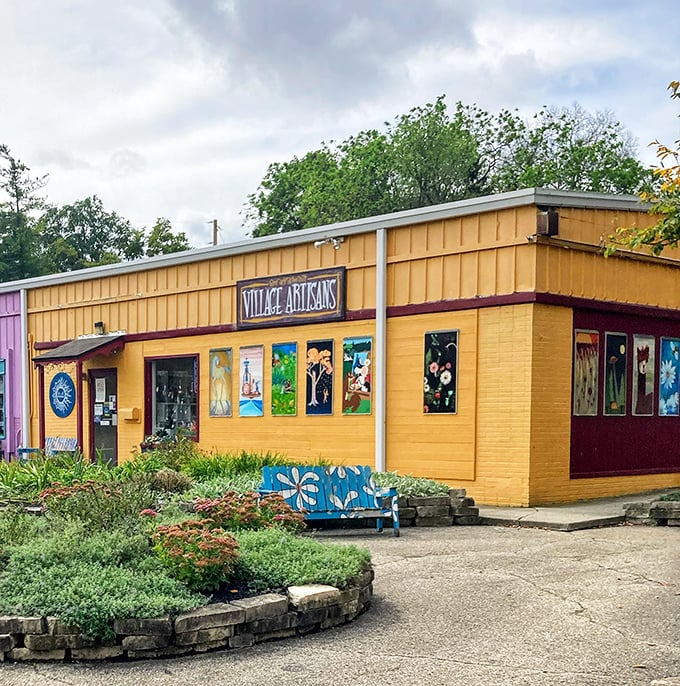 Village Artisans Co-Op bursts with color against the sky, its windows showcasing local creativity. Inside, every piece tells a story of craftsmanship.