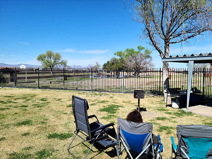Camping chairs positioned for maximum relaxation while keeping watchful eyes on swimming adventures.
