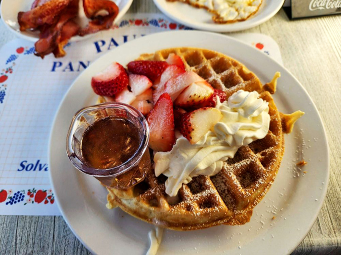 The Belgian waffle here isn't just a vehicle for toppings—it's a perfect balance of crisp exterior and fluffy interior that deserves its strawberry and whipped cream crown.