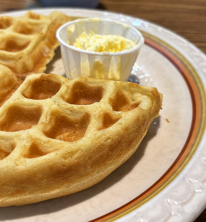 Golden waffles with deep pockets perfect for pooling butter and syrup. Breakfast architecture at its finest.