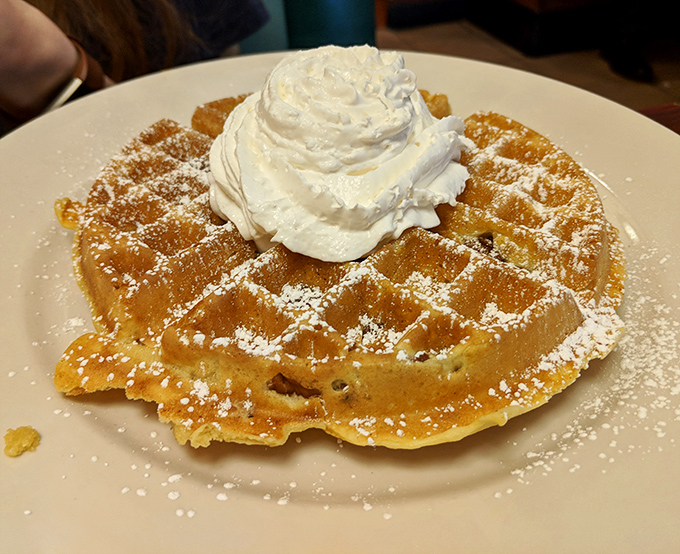 A waffle throne crowned with whipped cream that turns ordinary mornings into celebrations. Diet plans, consider yourselves postponed.