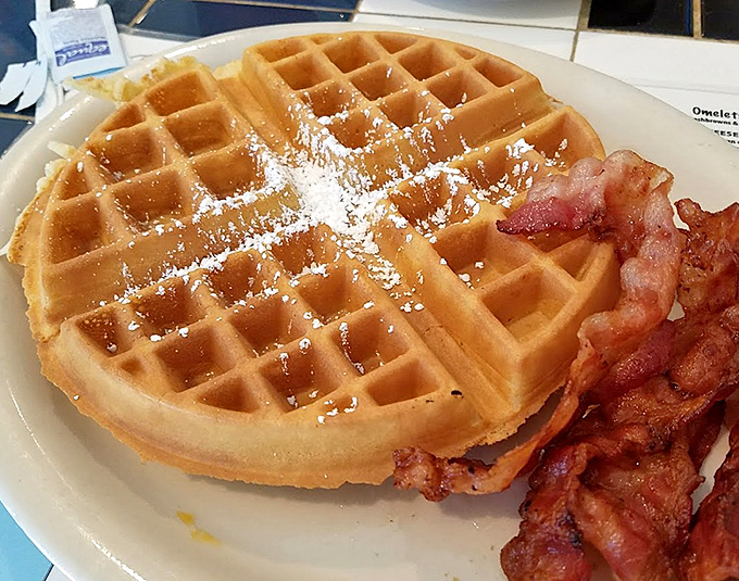 Waffles dusted with powdered sugar and bacon that's achieved peak crispiness, the breakfast dream team assembled.