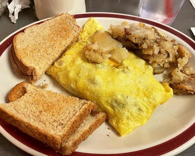 The Western omelet&mdash;where eggs meet their destiny alongside perfectly crisped hash browns and toast waiting for its butter bath.