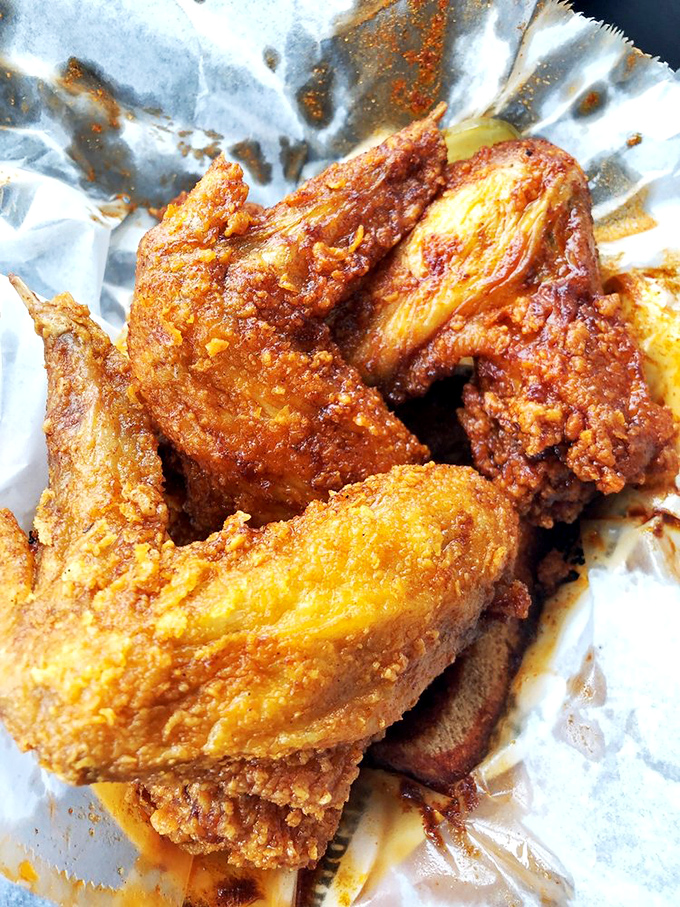 These wings aren't flying anywhere except straight to flavor town, their reddish glow a warning sign that delicious heat awaits.