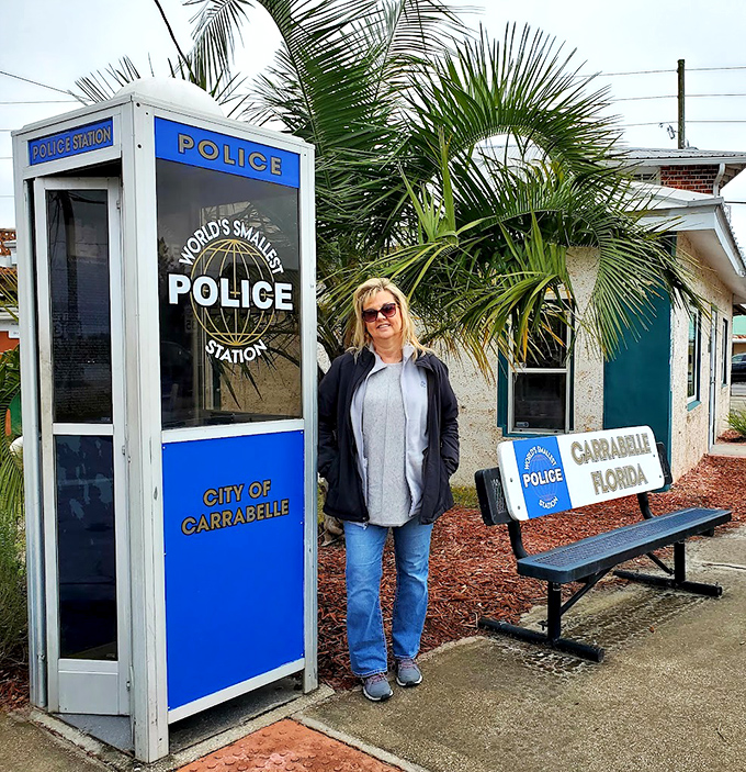 Size comparison is everything&mdash;this visitor demonstrates that the World's Smallest Police Station truly lives up to its name.