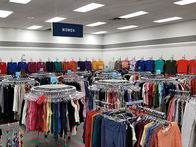 The women's clothing section: organized chaos at its finest, where color-coded racks create a rainbow road to fashion bargains.