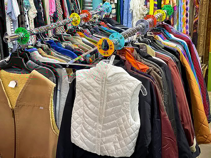 Color-coded clothing racks create a rainbow road map to style reinvention, where your next signature look is hiding between someone else's castoffs.