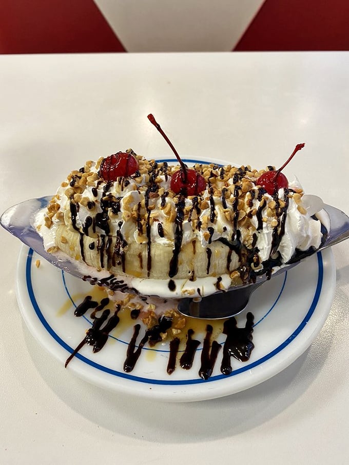 The banana split arrives like a dessert celebrity&mdash;whipped cream, cherries, nuts, and chocolate drizzle creating a sweet symphony that's worth every calorie.
