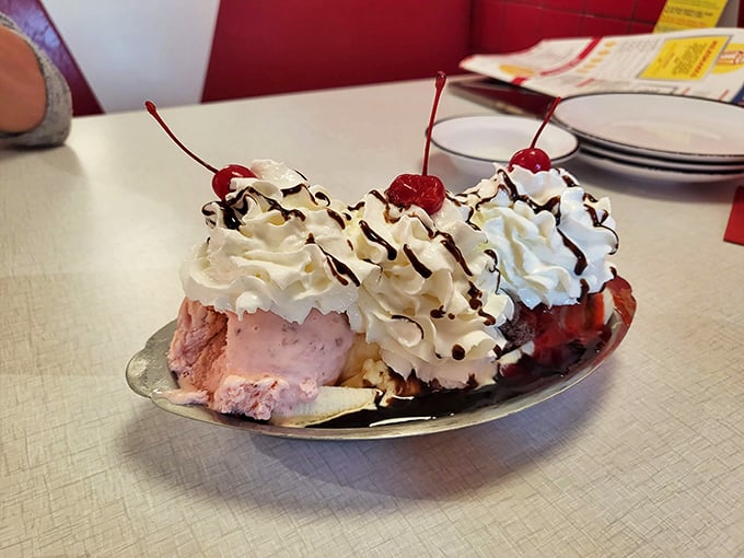 This banana split isn't just dessert, it's performance art &ndash; a symphony of ice cream, whipped cream, and cherries that makes adults remember what joy tastes like.