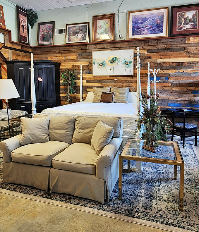 A four-poster bed with a cozy couch creates a furniture showroom vibe that makes you wonder why anyone pays retail.
