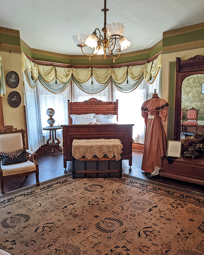 This bedroom isn't just preserved &ndash; it's ready for occupancy. That dress stands at attention, waiting for its owner to return from the 1880s any minute now.