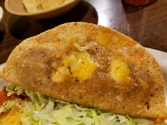 A plate that tells a story of tradition and care. The seasoned beef taco settles into its shell like it&rsquo;s been waiting all day for this moment.