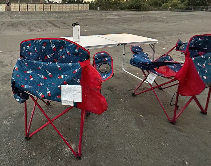 Early birds get the best spots! These patriotic chairs mark territory before the evening's cinematic adventure begins.
