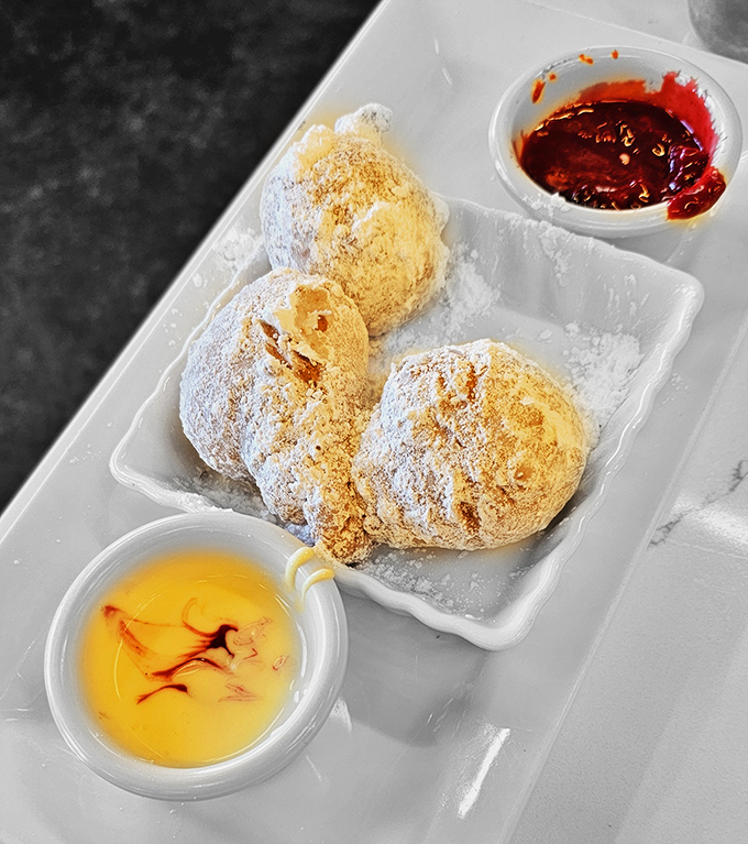 These beignets aren't just donut cousins&mdash;they're powdered pillows of happiness served with honey and berry compote for that perfect sweet-tart balance.