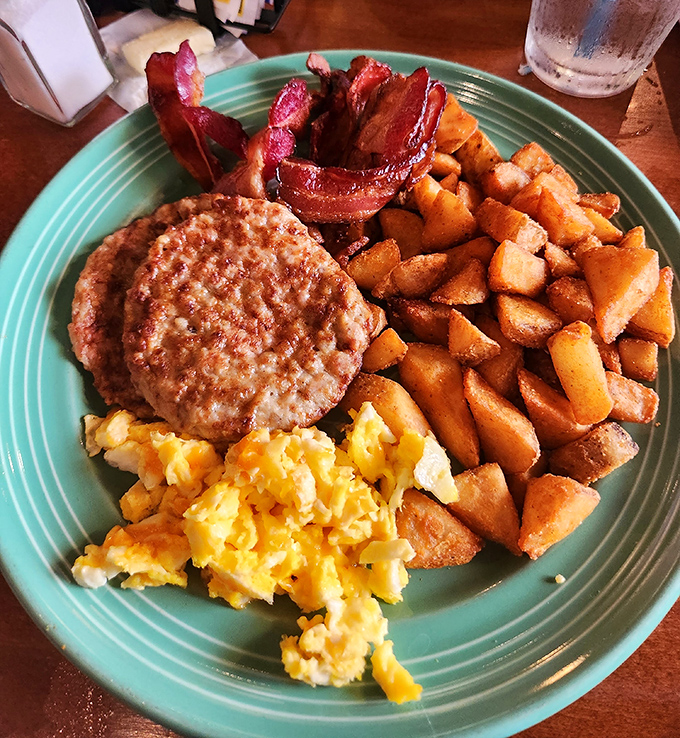The breakfast trinity: perfectly scrambled eggs, golden home fries, and bacon cooked to that magical point between chewy and crisp.