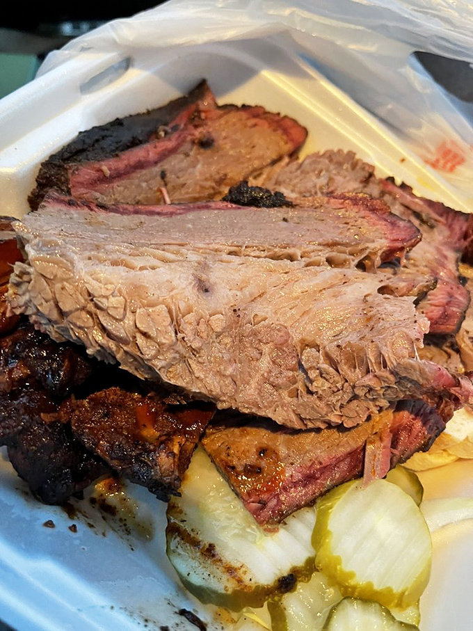 Brisket with a smoke ring so perfect it could be framed. The kind of meat that makes vegetarians question their life choices.