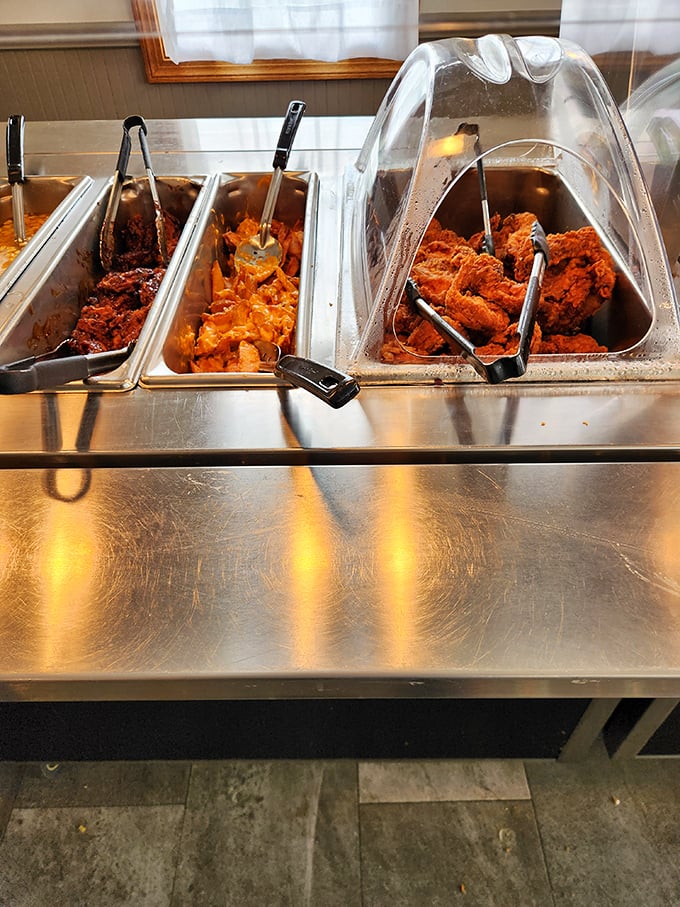 The buffet line—where dreams come true and belt notches go to die. Those golden fried chicken pieces are practically begging to jump on your plate.