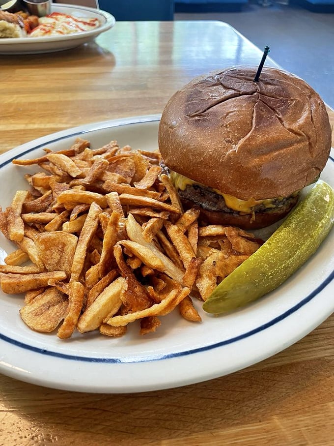 The burger and fries combo that launched a thousand cravings. That pickle stands guard like it knows something special is happening on that plate.