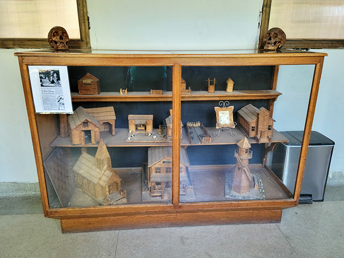 Folk art meets medical history. This display case showcases miniature wooden buildings, possibly created by patients during their long convalescence.