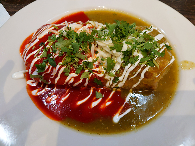 Half red, half green sauce creating a Mexican flag effect that's both patriotic and delicious. This burrito doesn't need a passport to transport you.