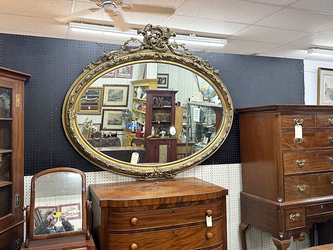 An ornate oval mirror reflects the market's endless possibilities, doubling the visual feast before you.