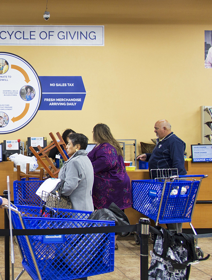 Blue shopping carts lined up at checkout, no doubt filled with treasures that cost less than a decent lunch.